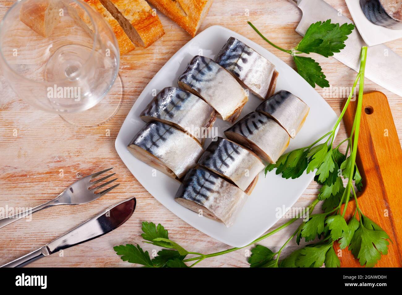 Slices of lightly salted mackerel with greens at plate Stock Photo - Alamy