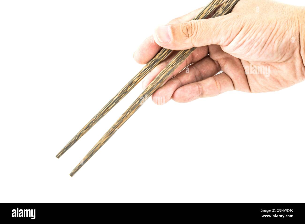 Wooden chopsticks in hand isolated on white background Stock Photo - Alamy