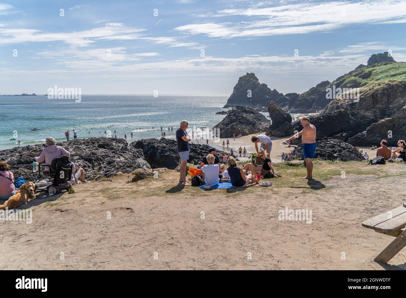 A group of people enjoying the cafe area at Kynance Cove in Cornwall ...