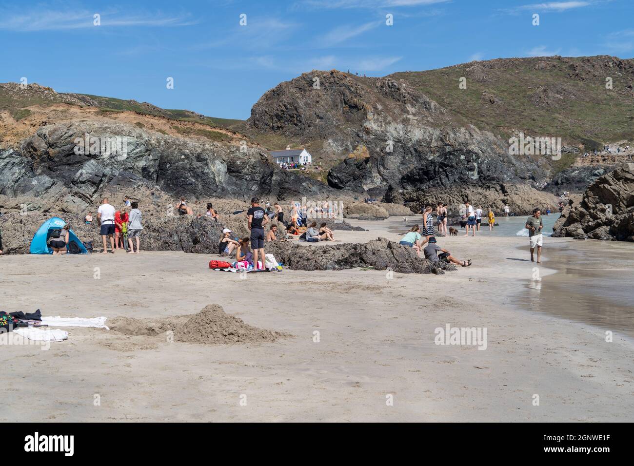 Holiday makers enjoy the beach at Kynance Cove in Cornwall. Kynance ...