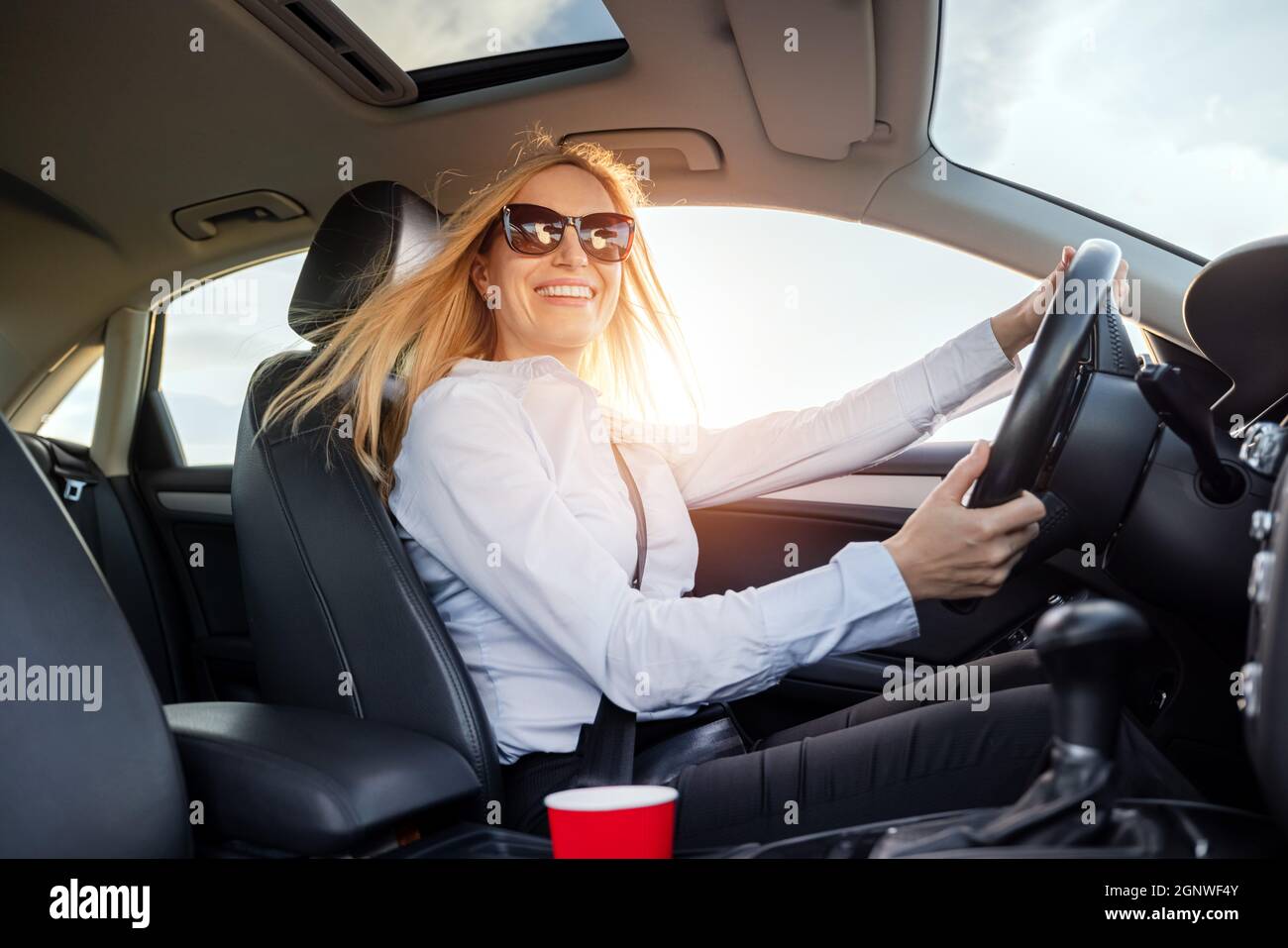 Happy woman driving car Stock Photo - Alamy