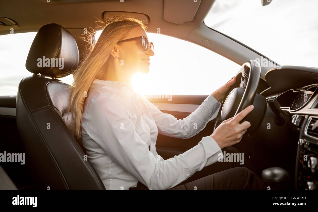Female driver driving car Stock Photo - Alamy