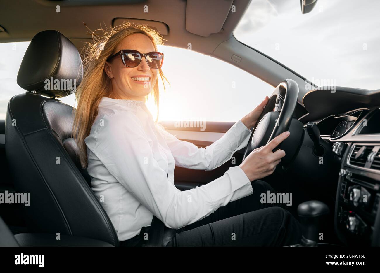 Happy business lady driving car Stock Photo - Alamy