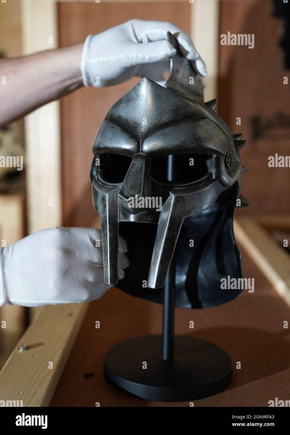 A Prop Store employee adjusts Russell Crowe's 'Maximus' arena helmet ...