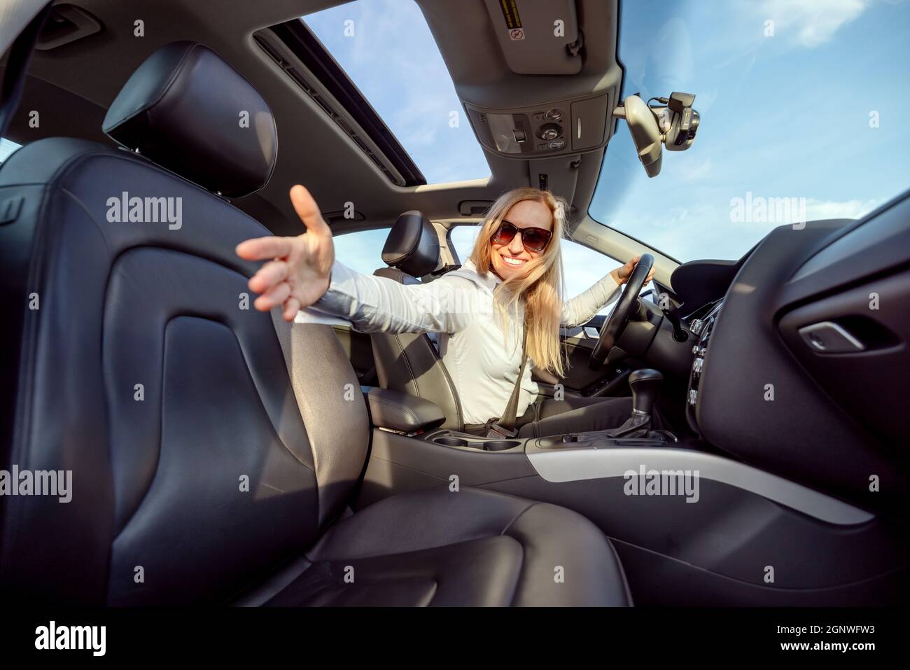 Woman in car giving lift Stock Photo - Alamy