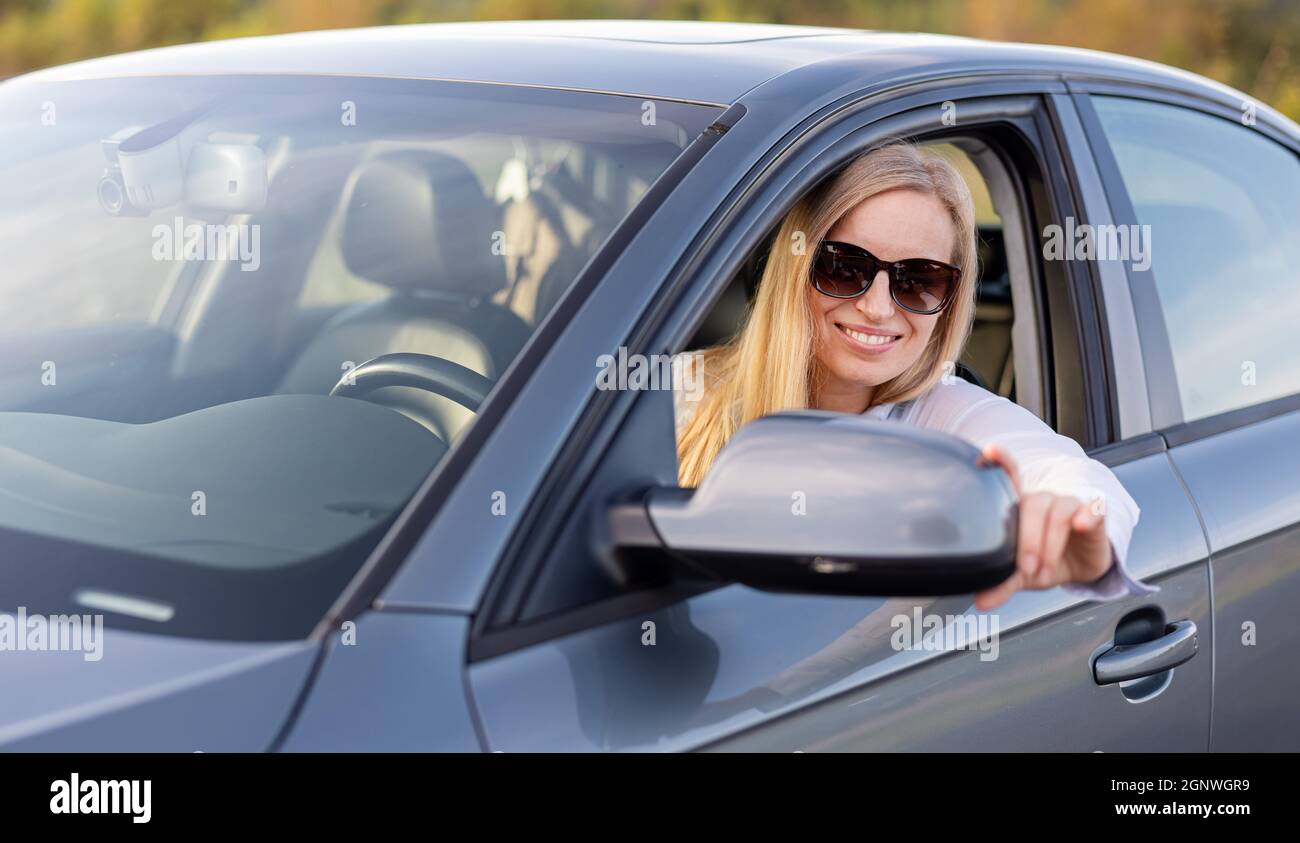 Car driver adjust side mirror Stock Photo - Alamy