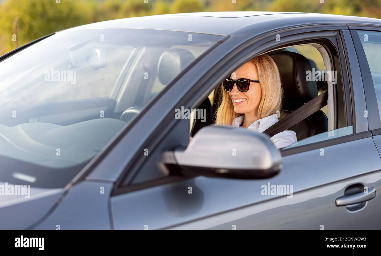 Confident woman driving car Stock Photo - Alamy