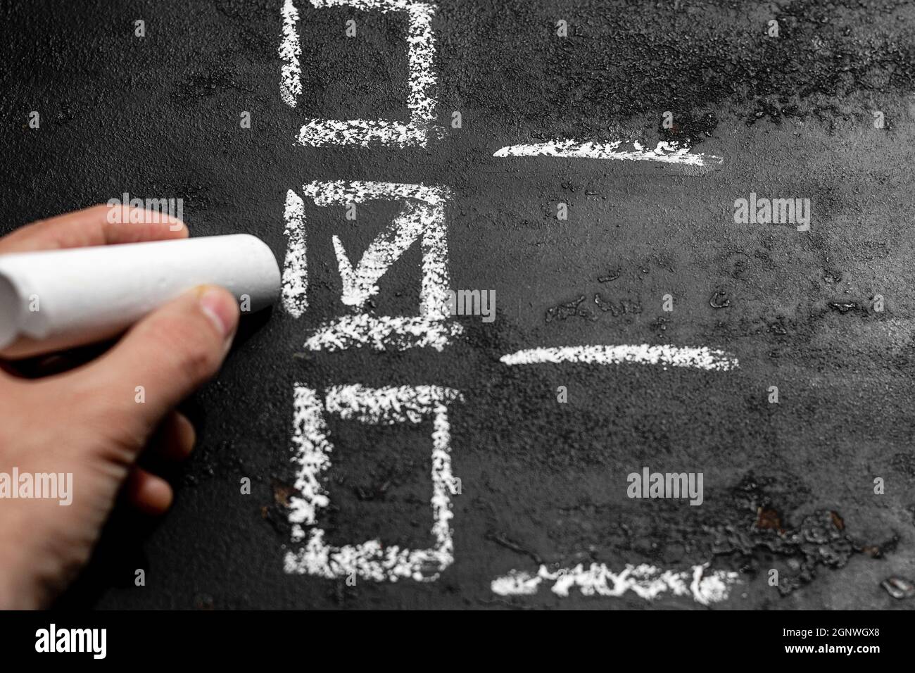 hand holds chalk and makes a choice. voting, checklist, option ...