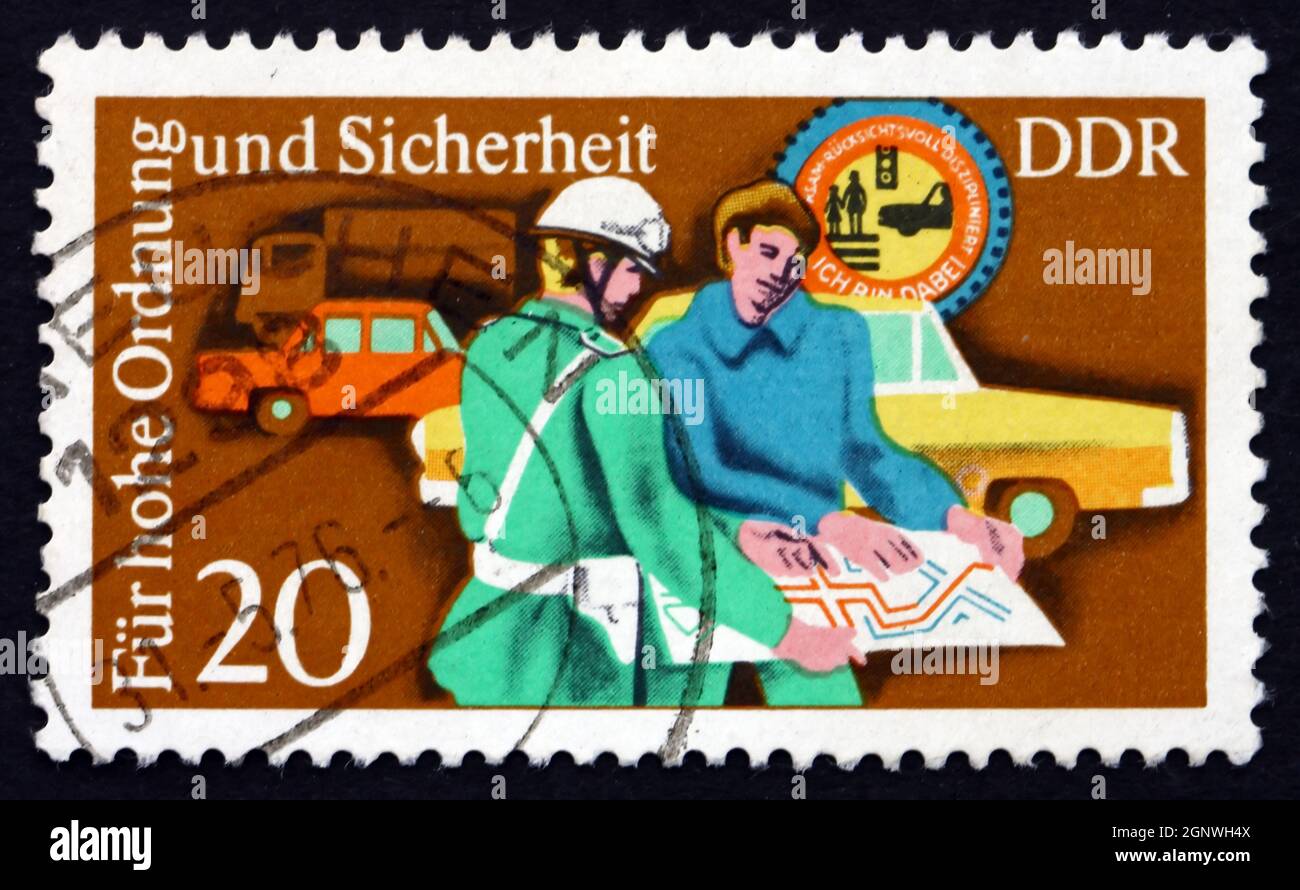 GDR - CIRCA 1975: a stamp printed in GDR shows Policeman Helping ...