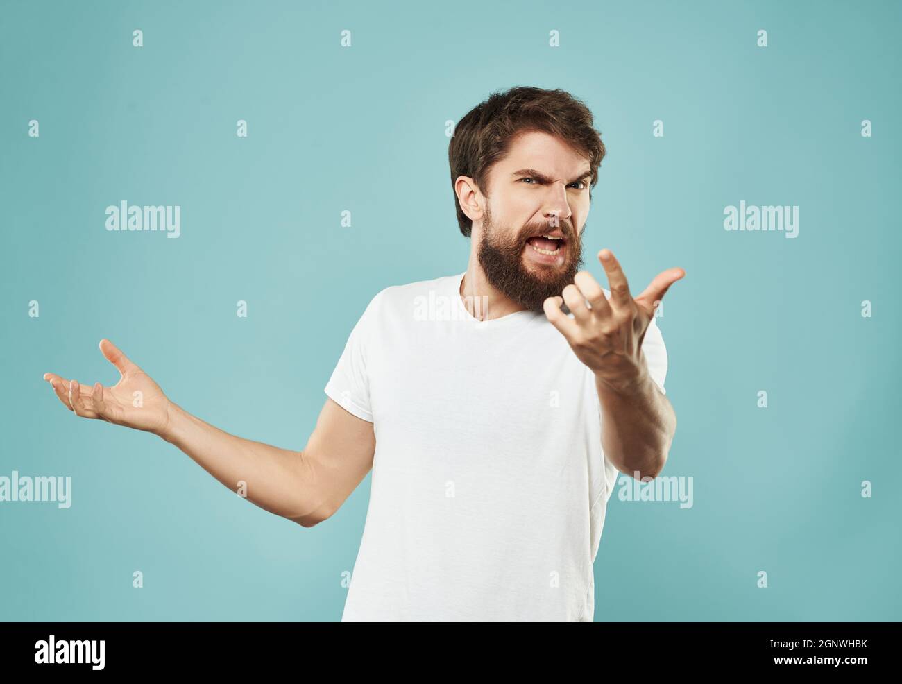 emotional man in a white t-shirt hand gestures anger Lifestyle Stock ...
