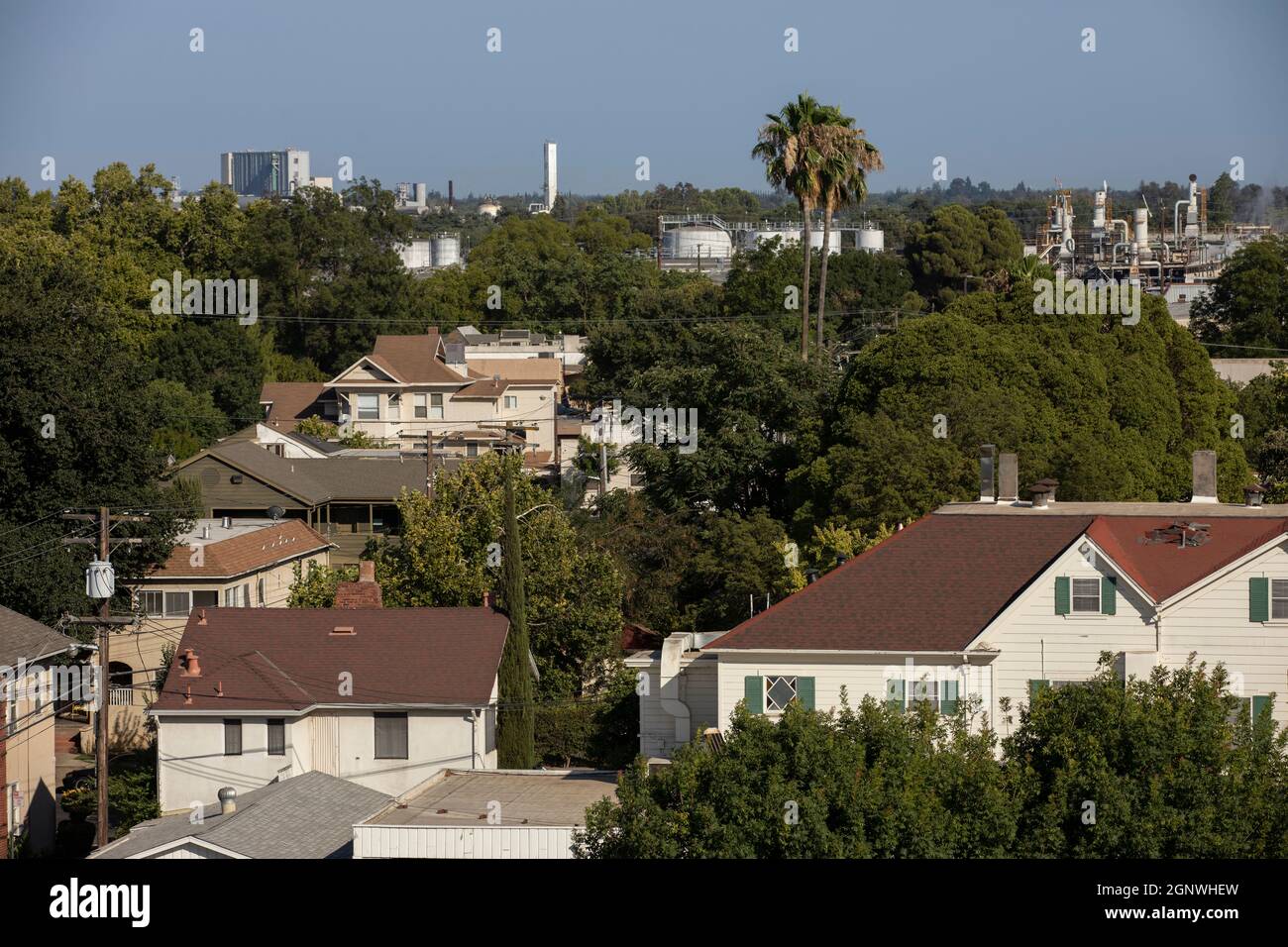 Afternoon aerial view of a neighborhood and industry near the urban ...