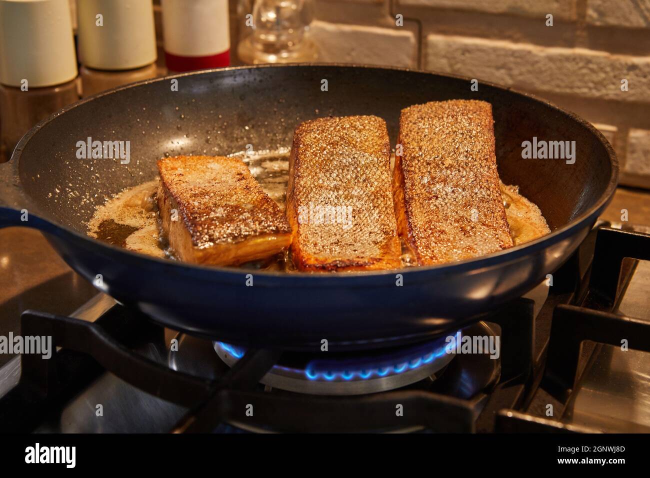 Fresh fillets of Solomon fish are fried in pan on gas stove Stock Photo ...