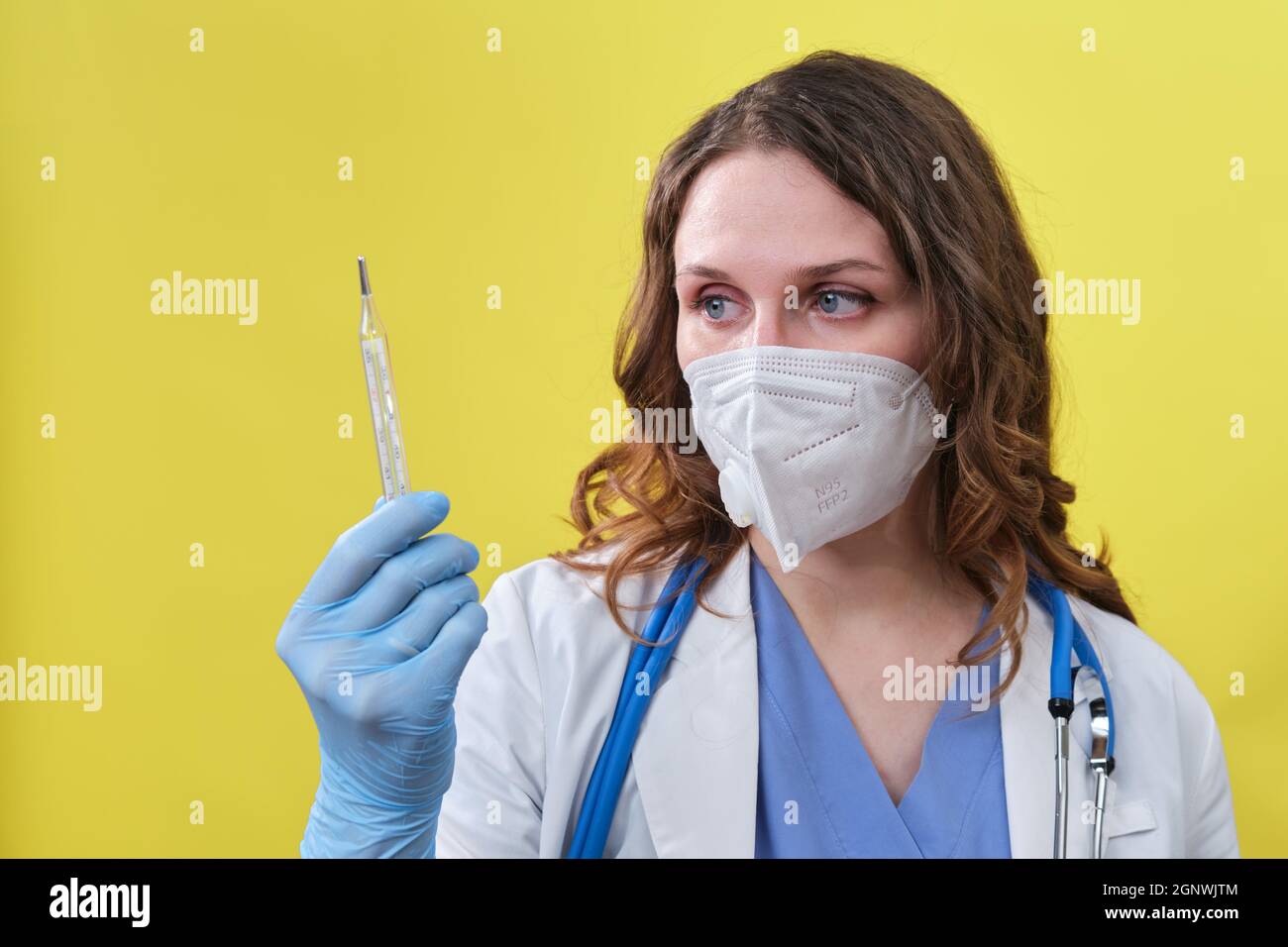 Woman doctor holds a mercury thermometer in her hand. Medical ...