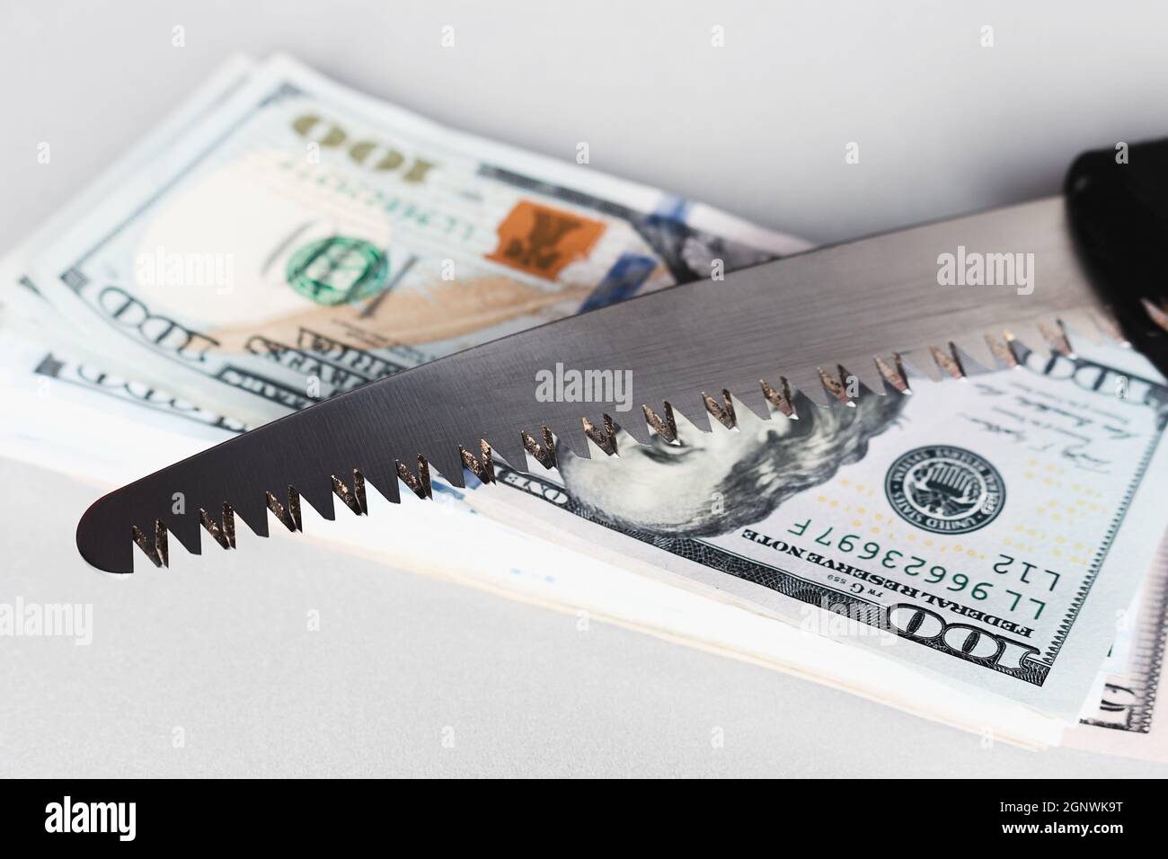 saw and money dollars close up corruption concept Stock Photo - Alamy