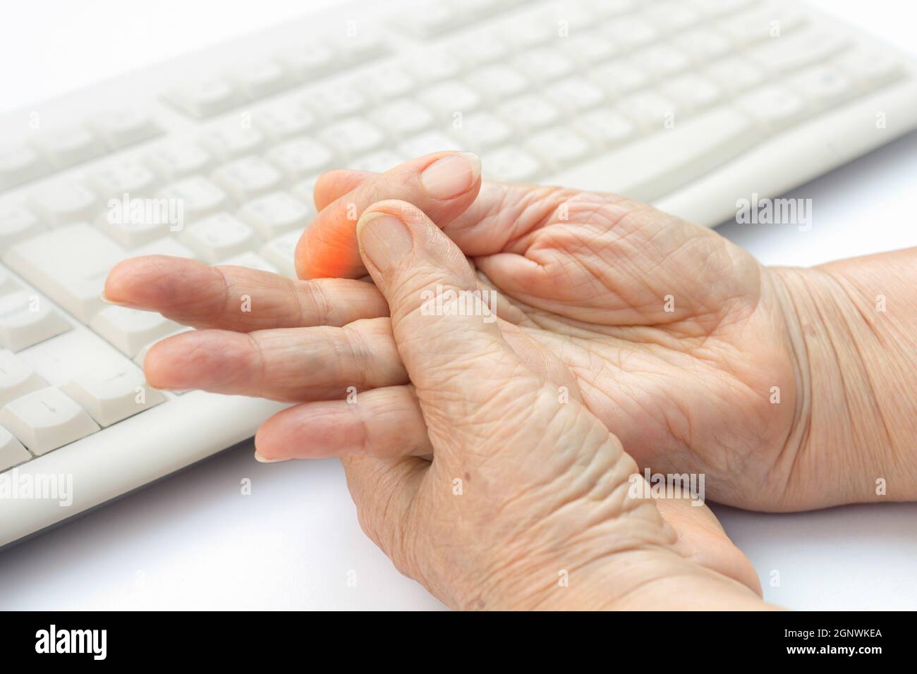 Senior woman painful finger due to prolonged use of keyboard and mouse ...