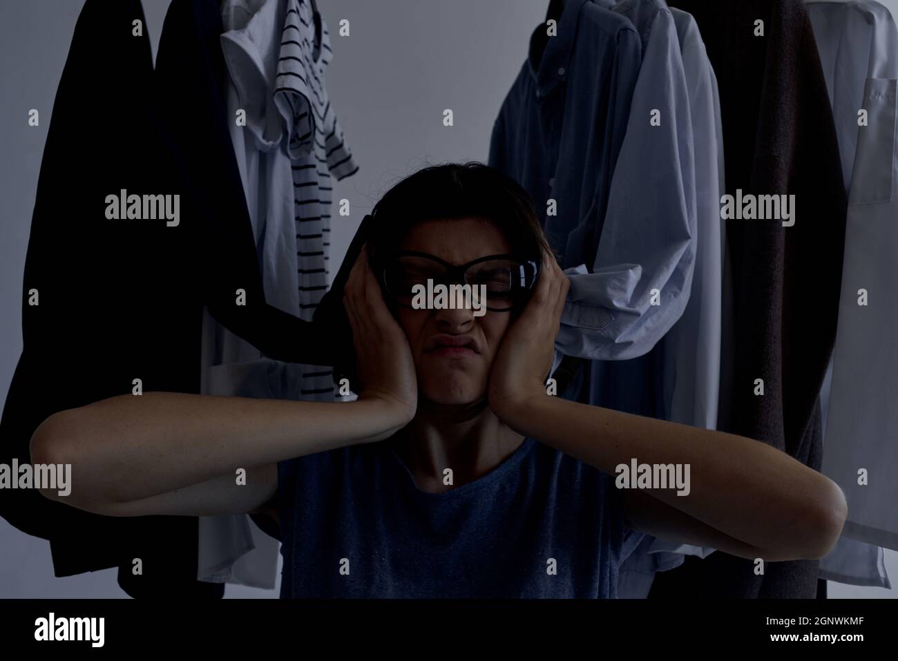 pretty woman selection of clothes near the wardrobe light background ...