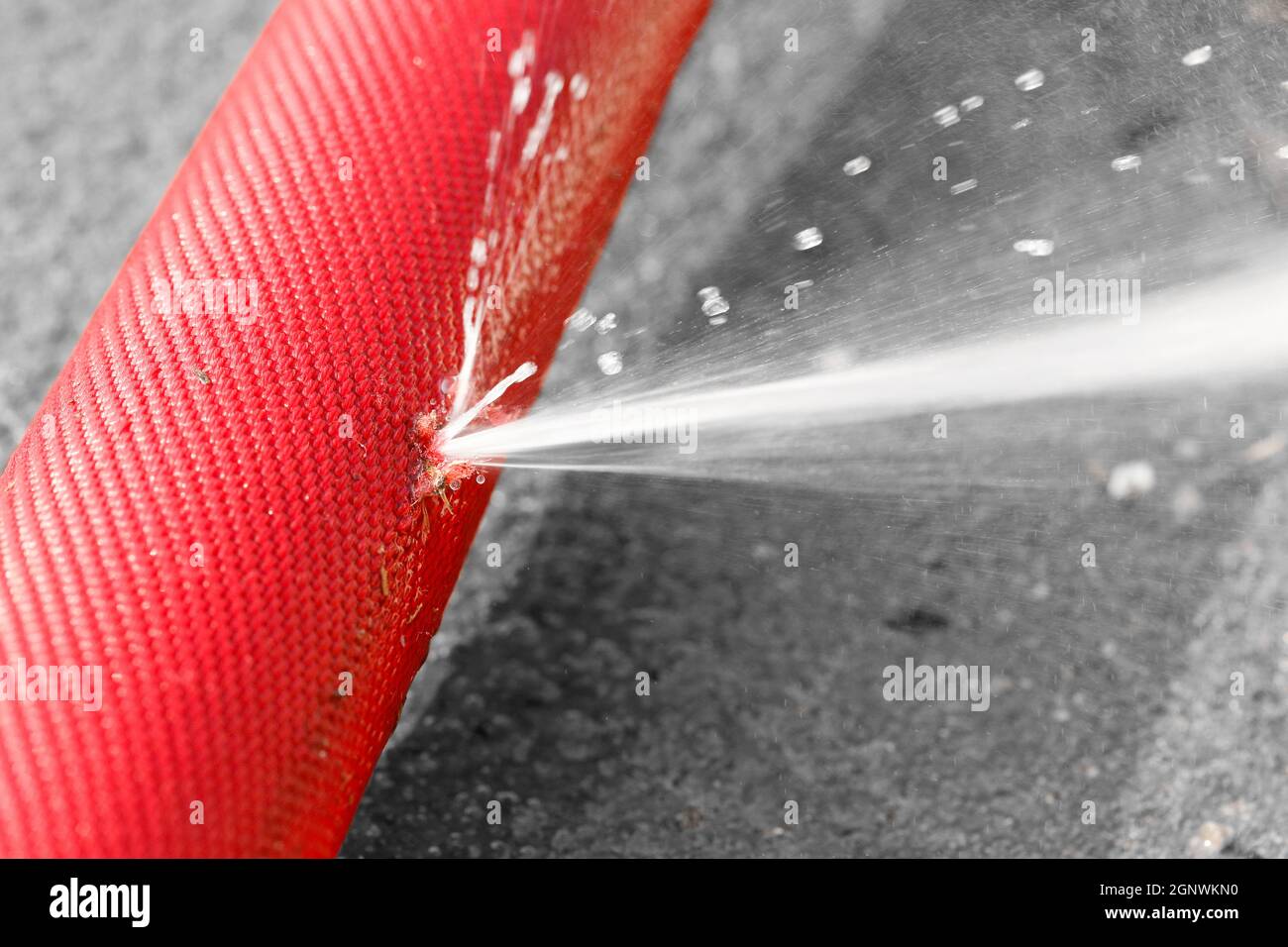 water leaking from hole in a hose Stock Photo - Alamy