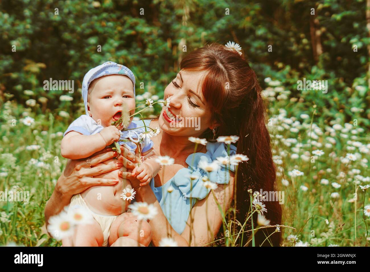 mother raises the child in her arms Stock Photo - Alamy