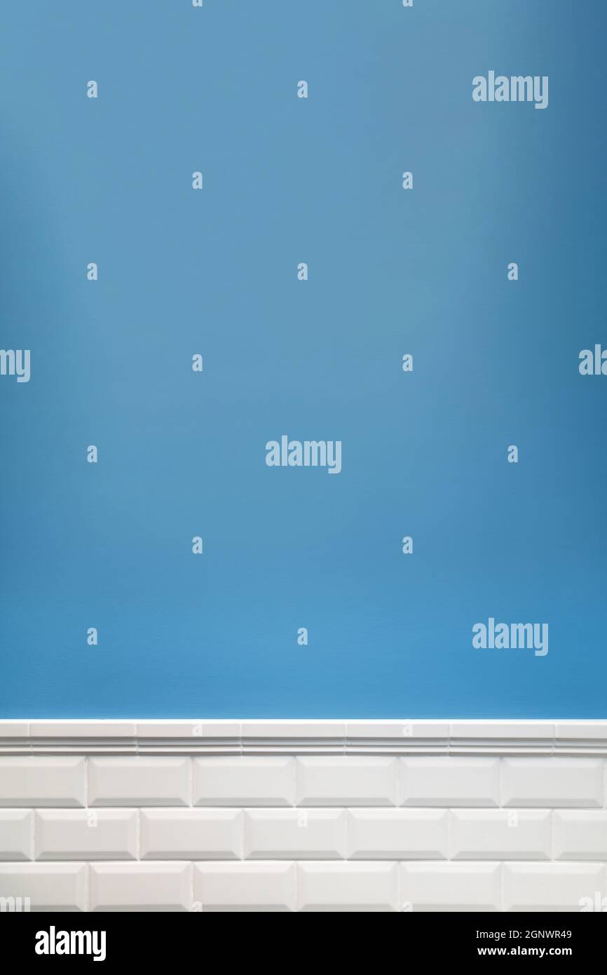 Bathroom wall design. Wall is painted in blue and tiled with white hog ...