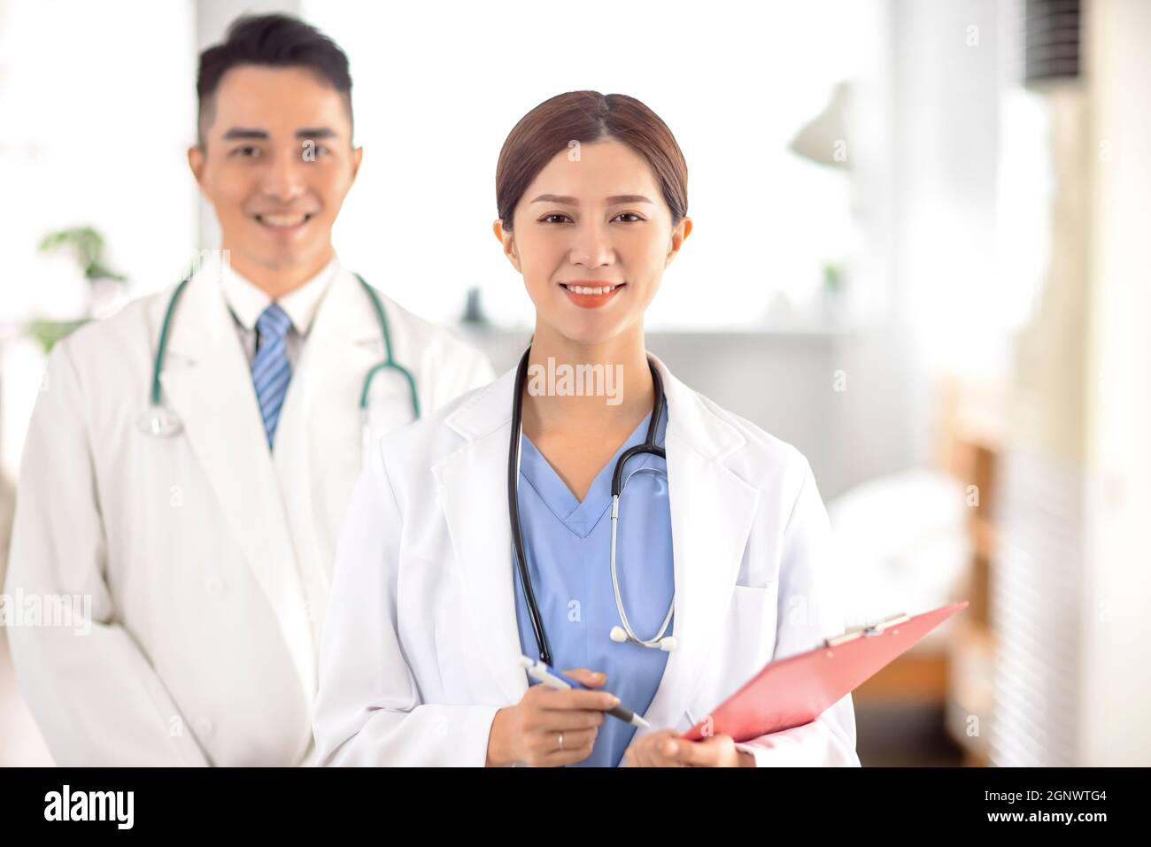 two doctors smiling and standing in Hospital Stock Photo - Alamy