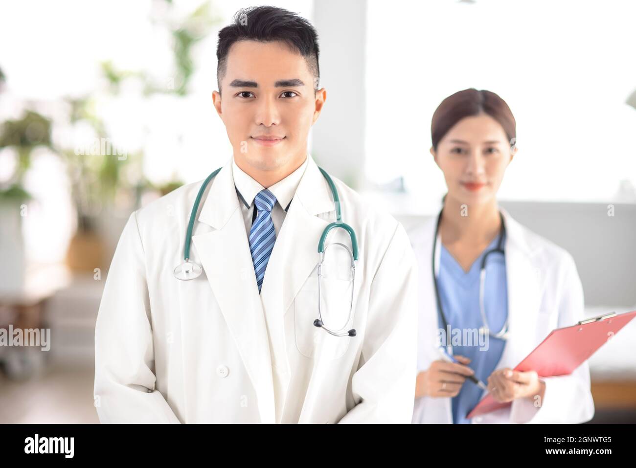 Happy doctors standing in office hi-res stock photography and images ...