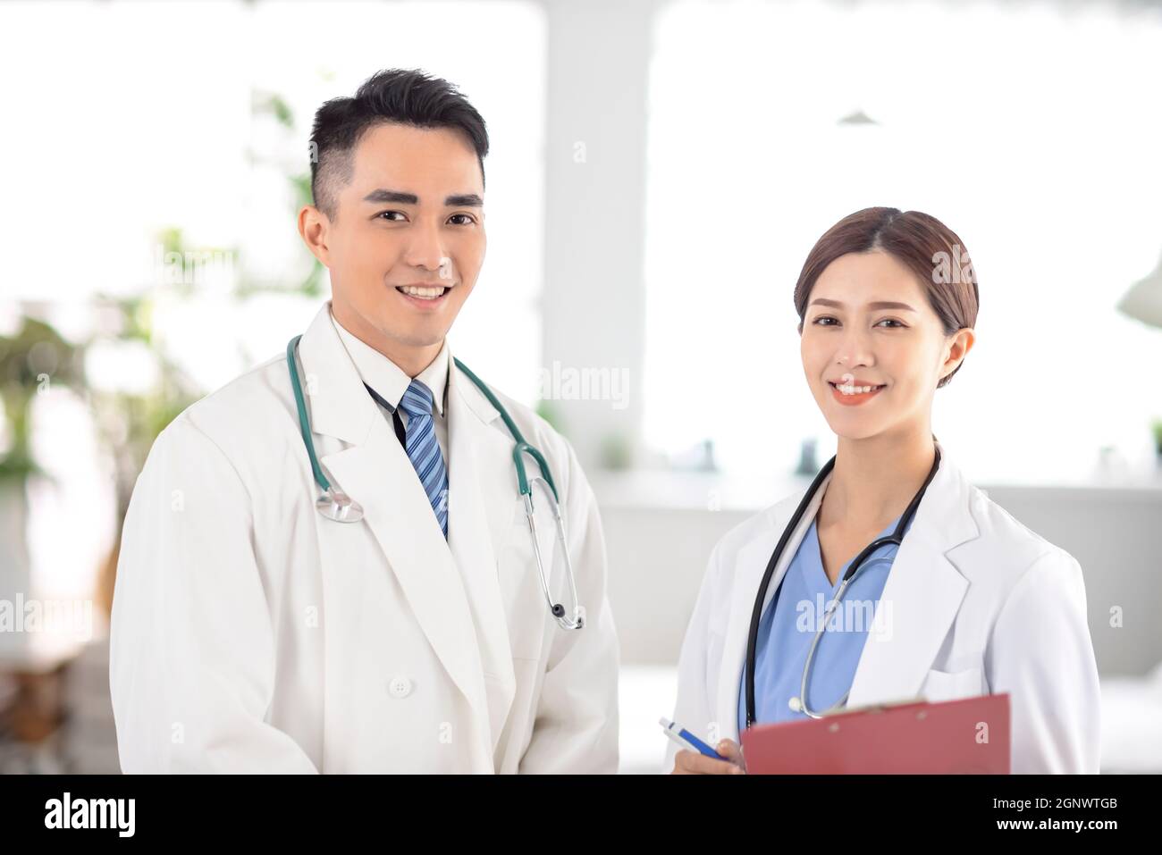 two doctors smiling and standing in Hospital Stock Photo - Alamy