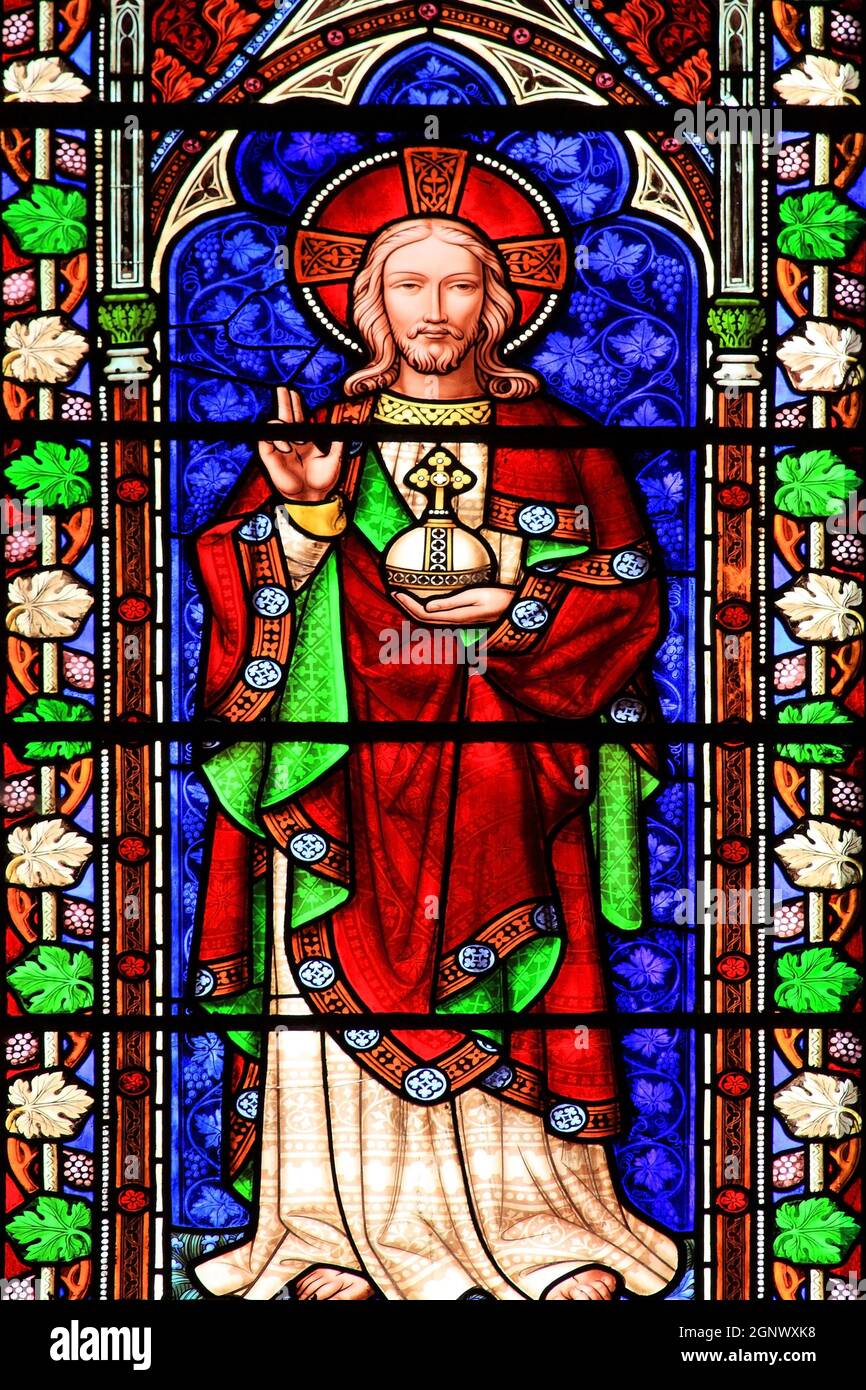 Jesus Christ shown in an image on a medieval stained glass window panel ...