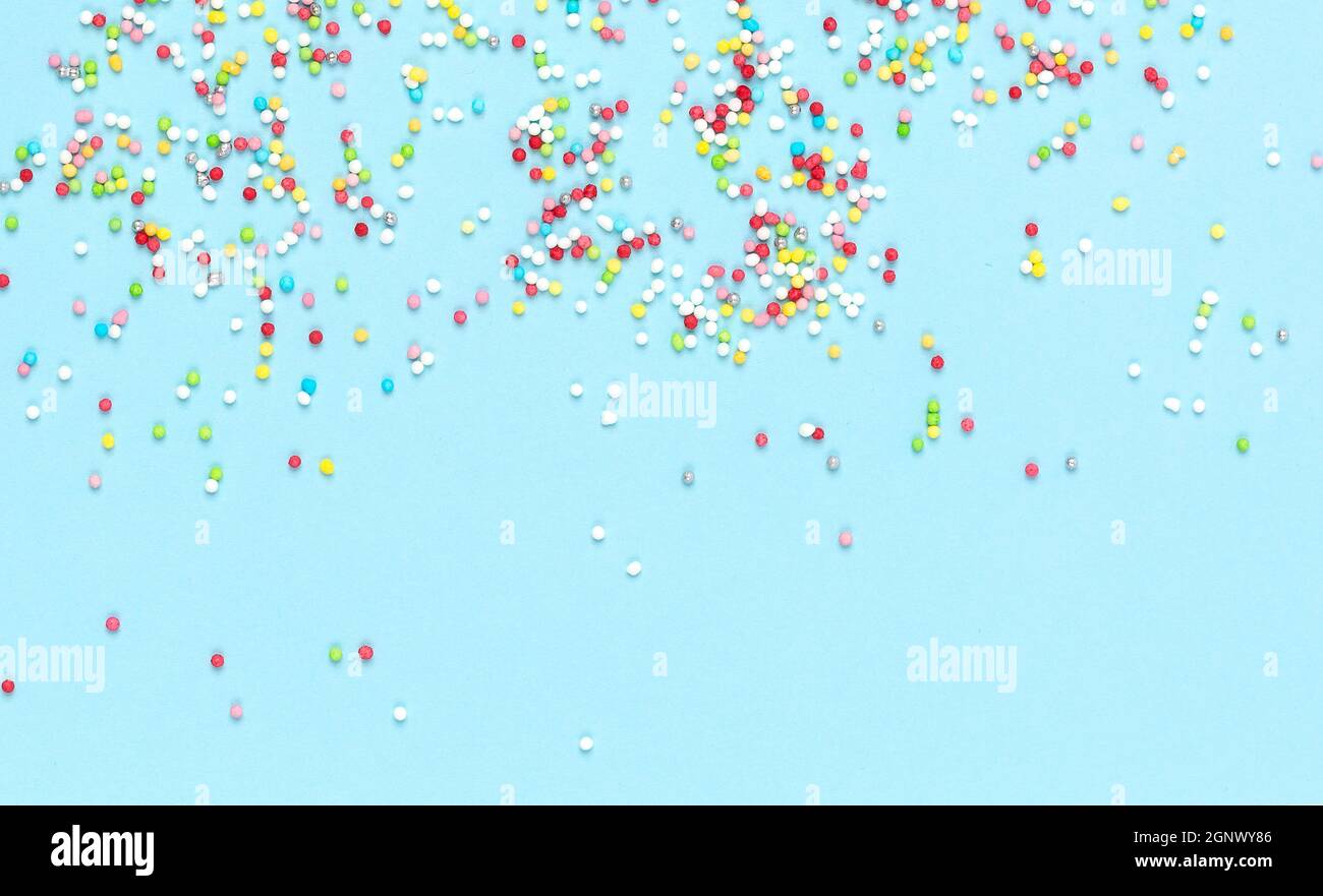 Multicolored candies for sweets on light blue background. Flat lay ...