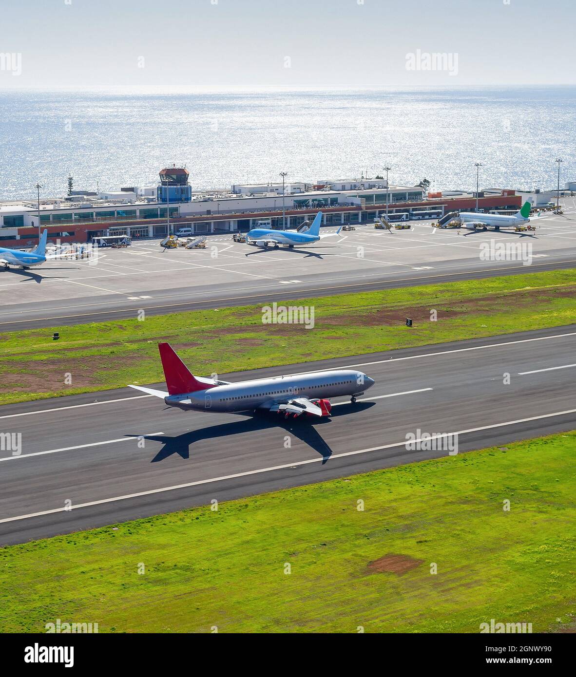 Aerial view of Funchal international airport with planes by terminal ...