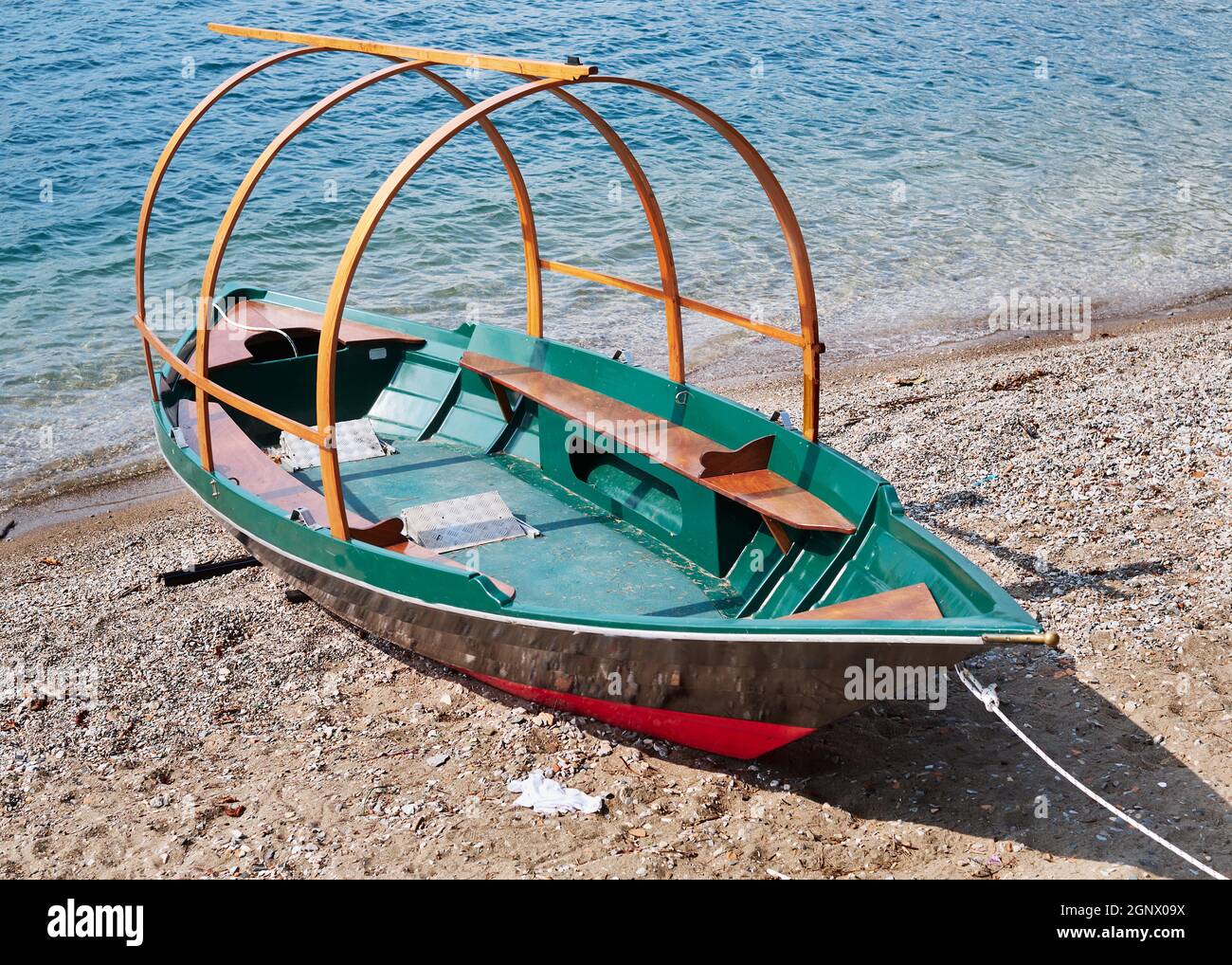 Italian traditional boat called Lucia anchored on the lake Como shore ...