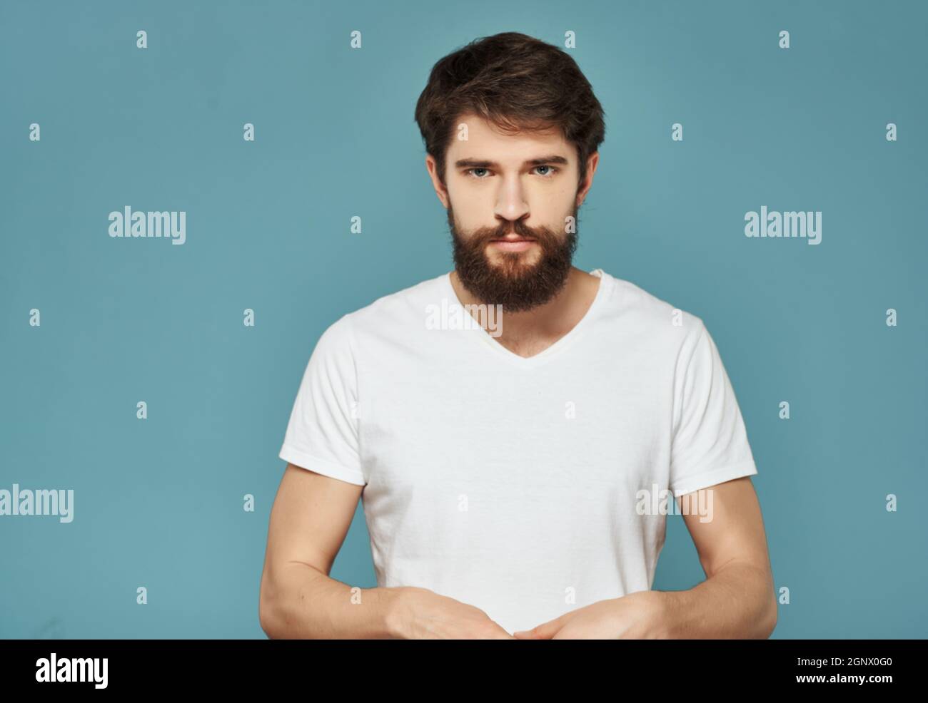 bearded man in a white t-shirt irritated facial expression close-up ...