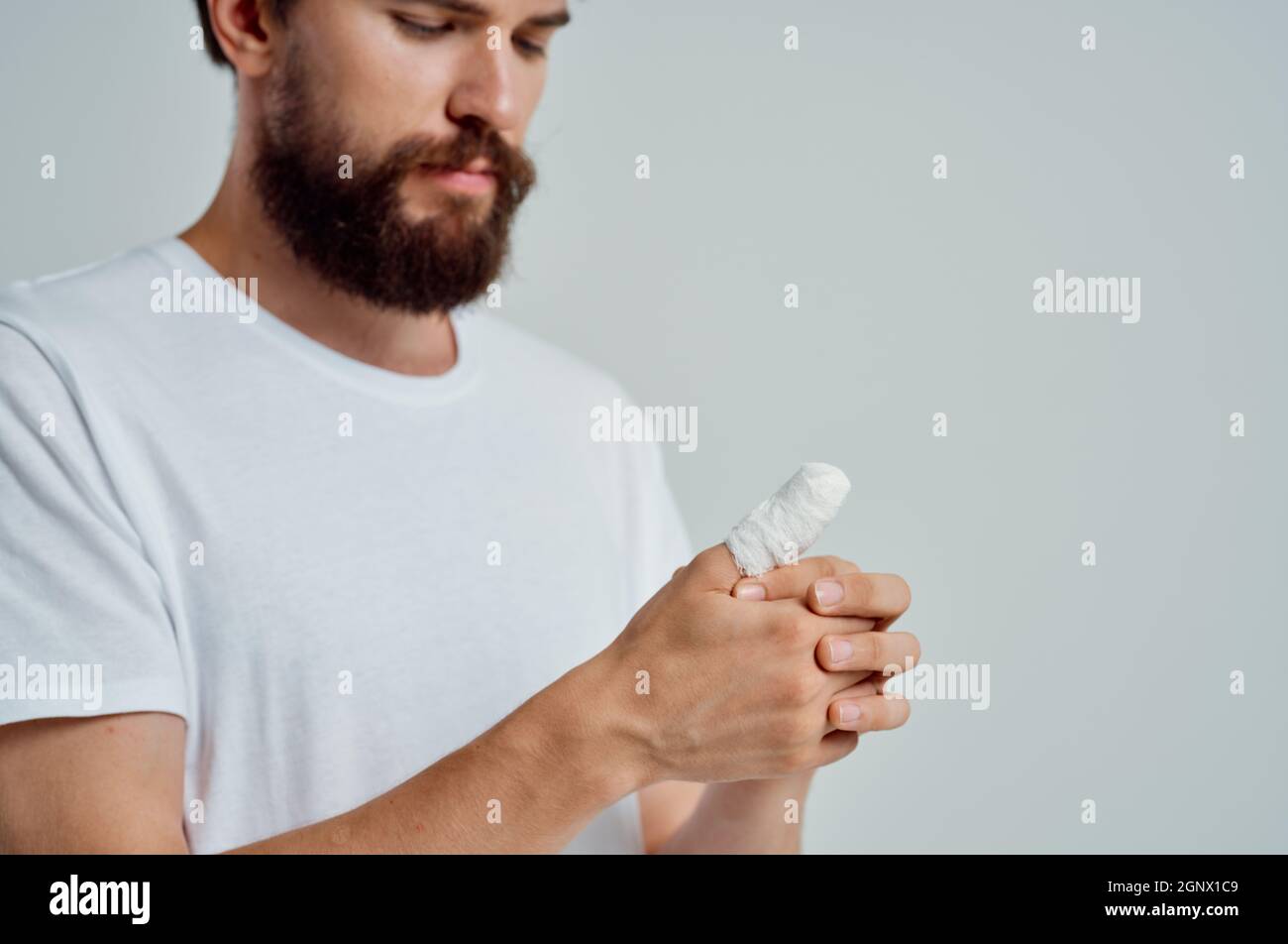 male patient bandaged hand injury to fingers isolated background Stock ...