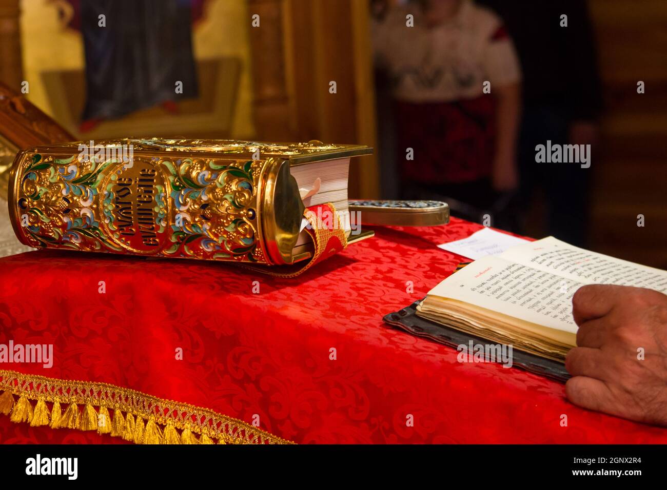 A priest holding the Bible at a christian ritual. Christian celebraton ...