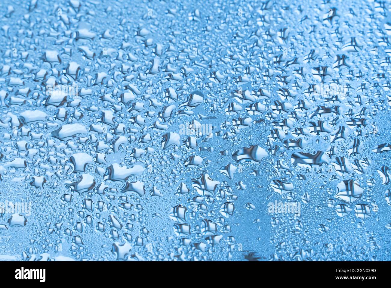 Wet glass with large drops of water or rain of blue color. Background ...