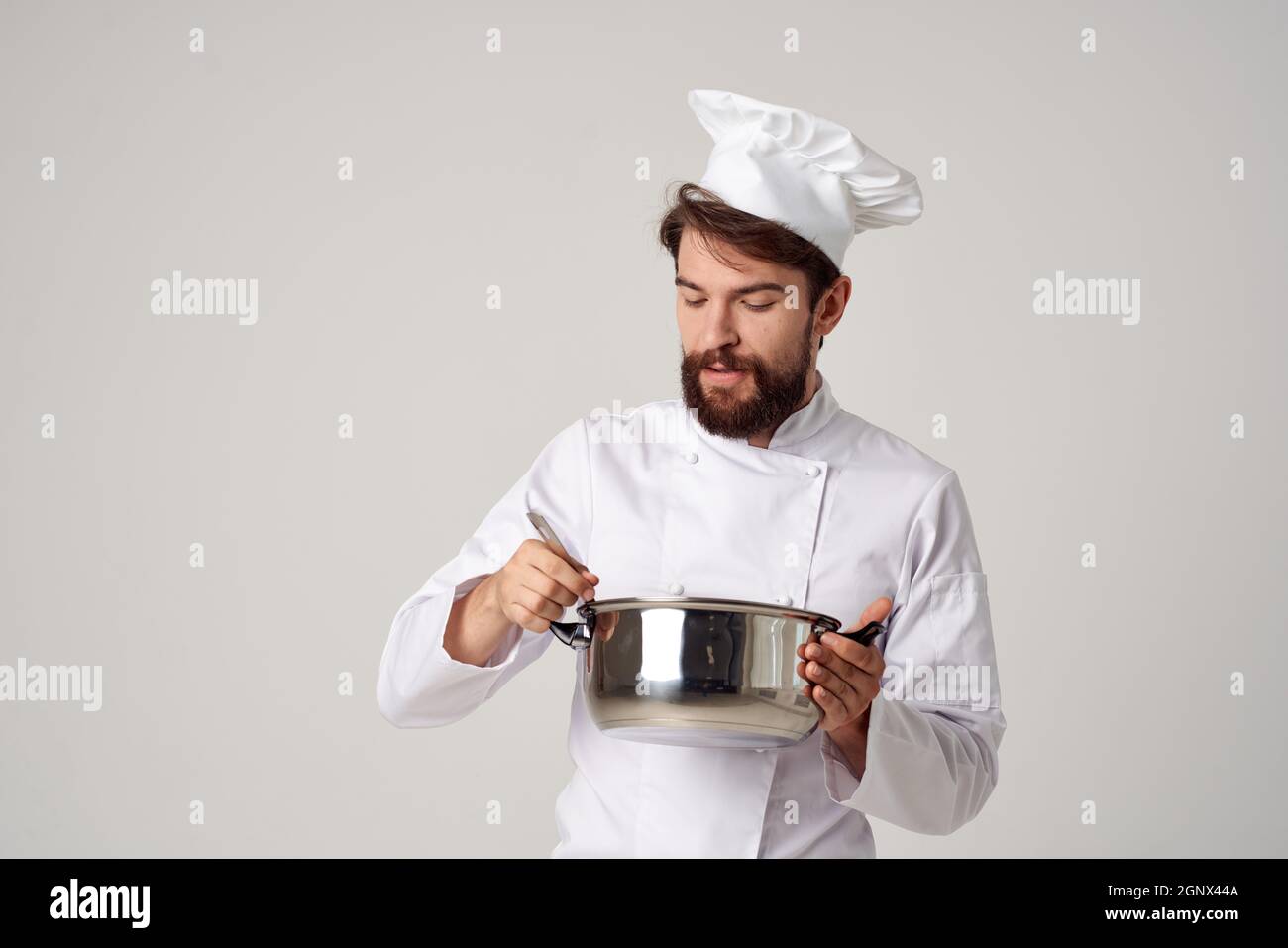 emotional male chef with a saucepan in his hands cooking restaurant ...