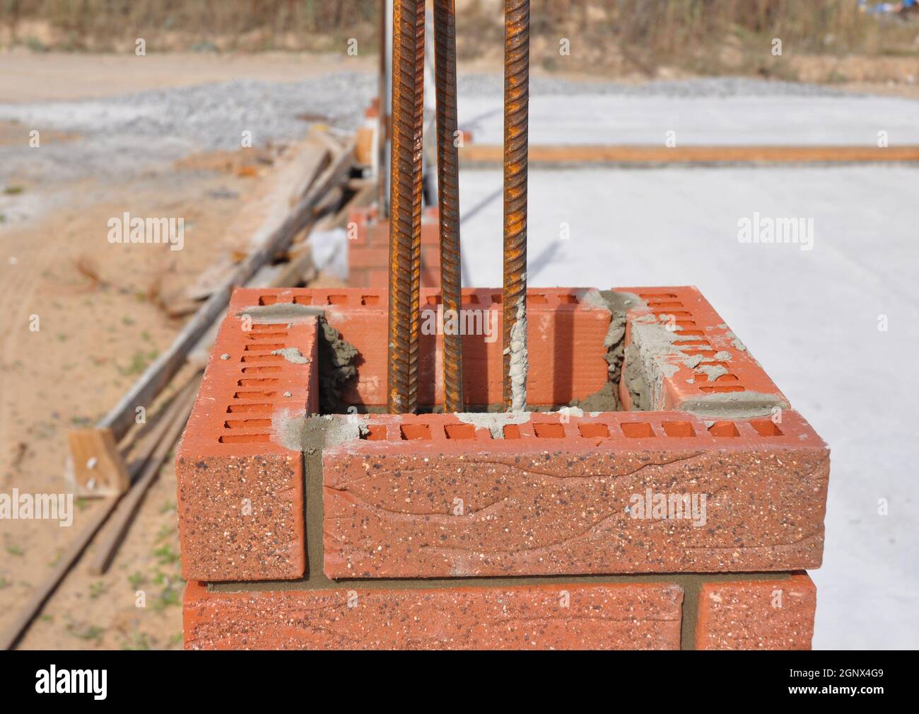 Building construction column with iron bars from brick blocks outdoor ...
