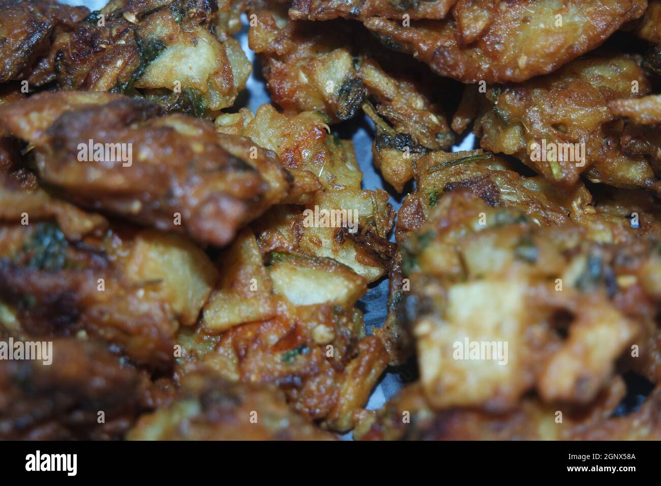 close-up view with selective focus of crispy basin pakora/pakoda or ...