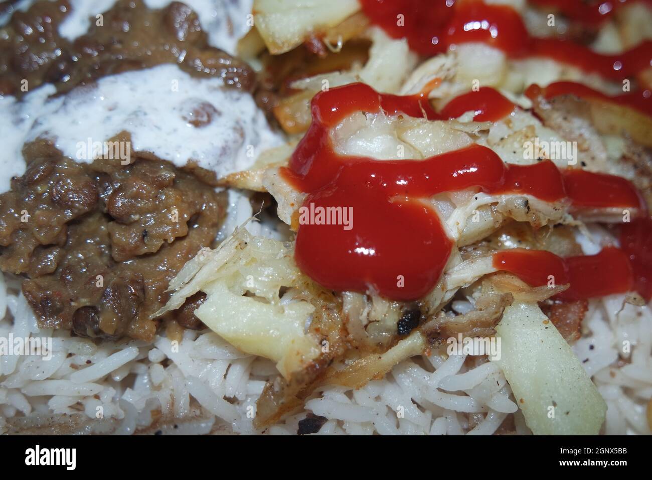 Delicious traditional dish of rice with potato fries and cereals with ...