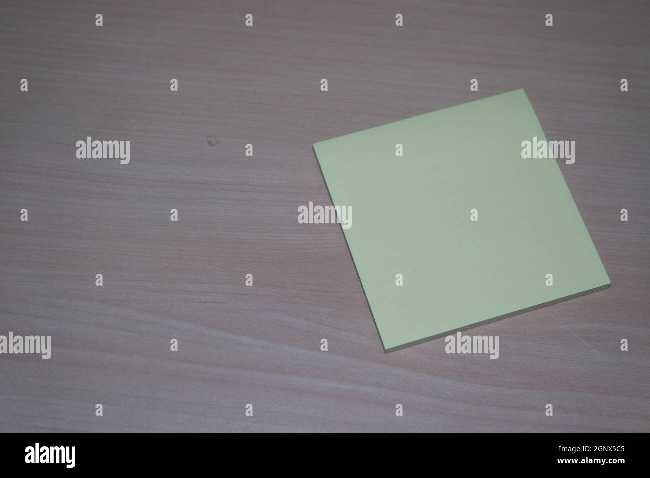 Close-up, selective focus: Yellow sticky note paper placed on a wooden ...