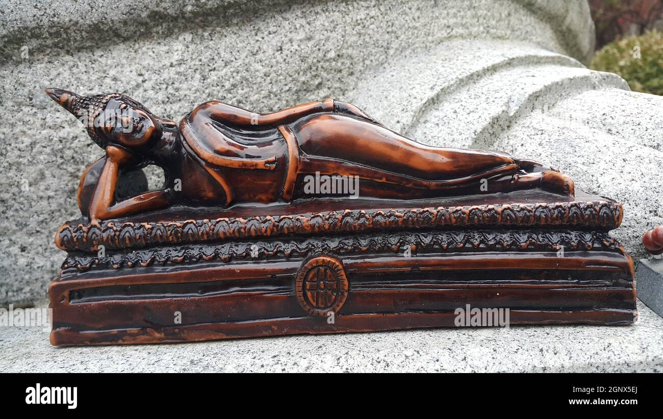 Closeup view of statues of religious monks. Buddha mini statue with ...