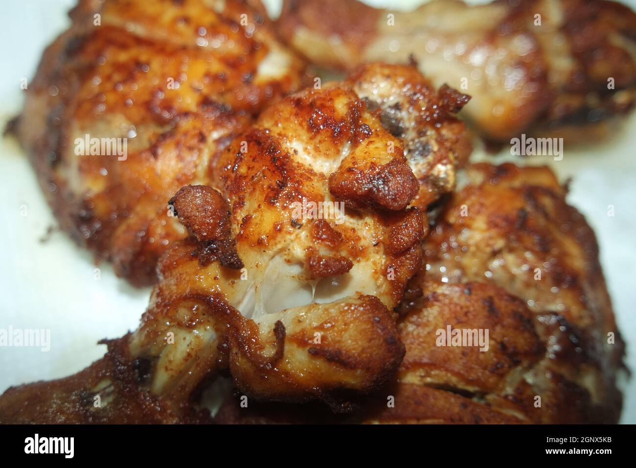 Fried, grilled baked chicken pieces with marinated spices on it. Tasty ...