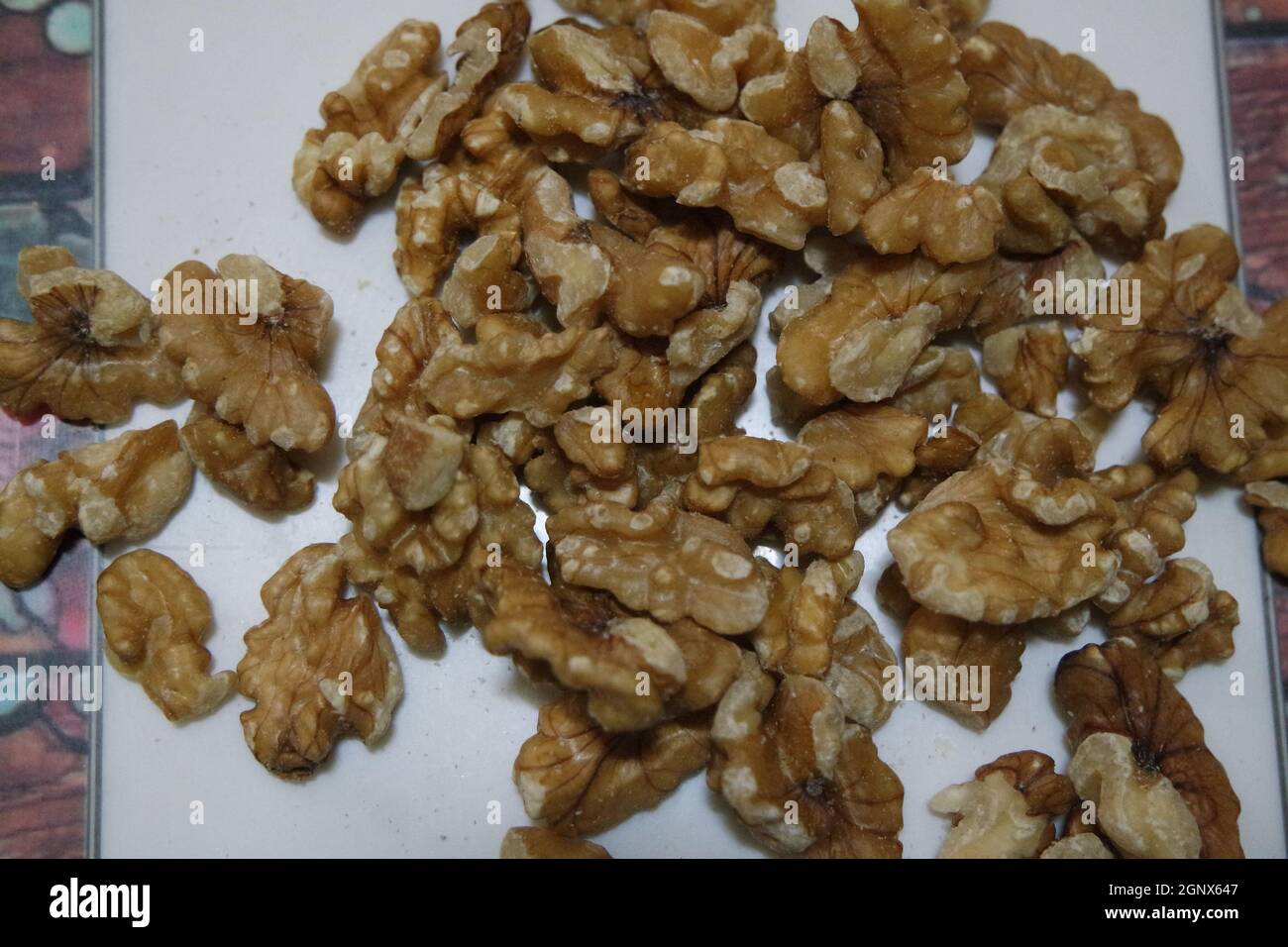 Close-up top view of peeled walnut on a white background. peeled walnut ...