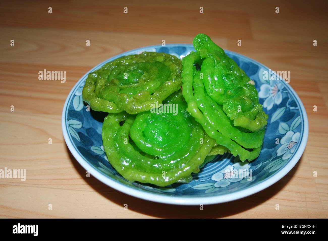 Crispy sweet Asian dessert green Jalebi cooked and served in ceramic ...
