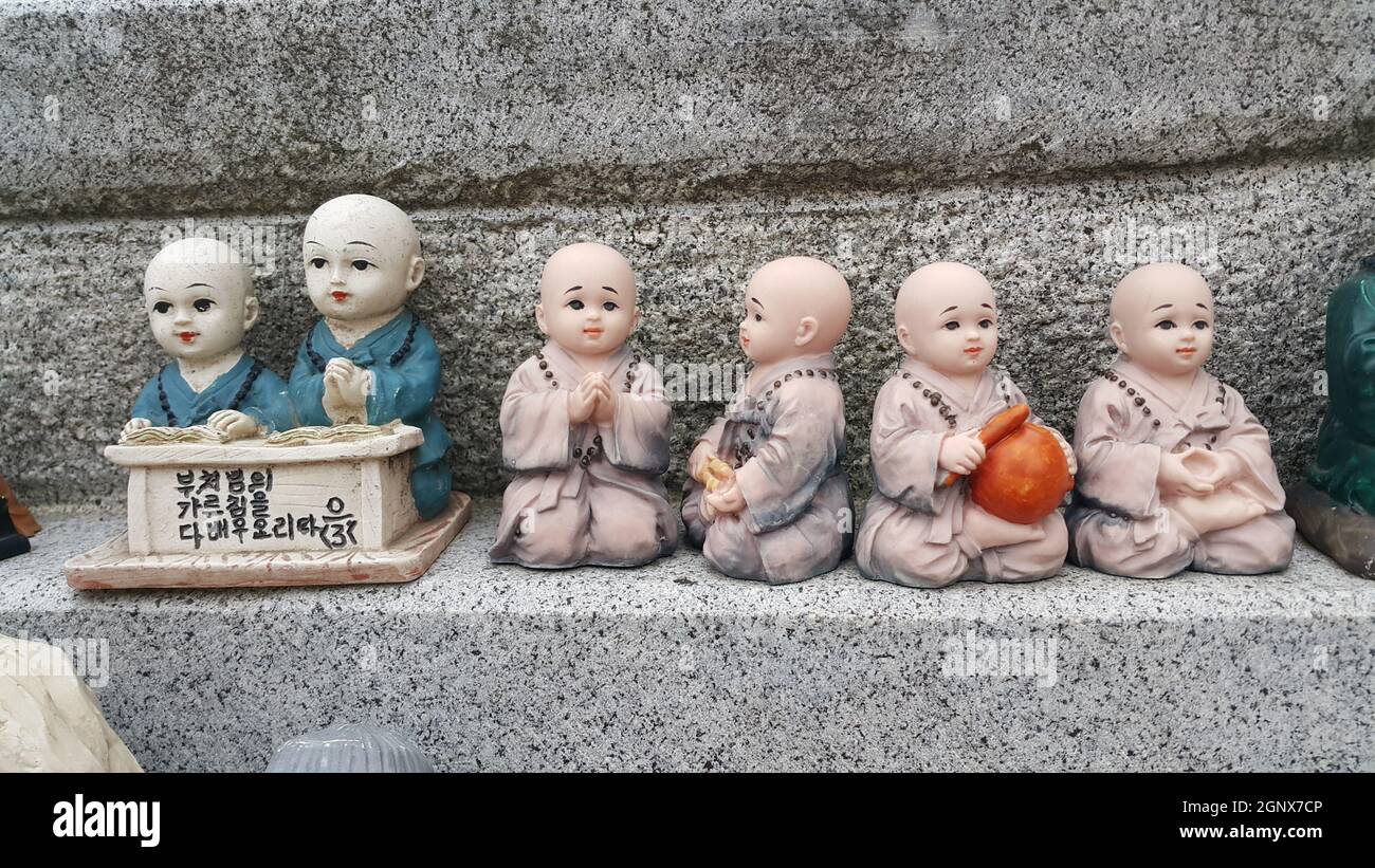 Closeup view of statues of religious monks. Buddha mini statue with ...