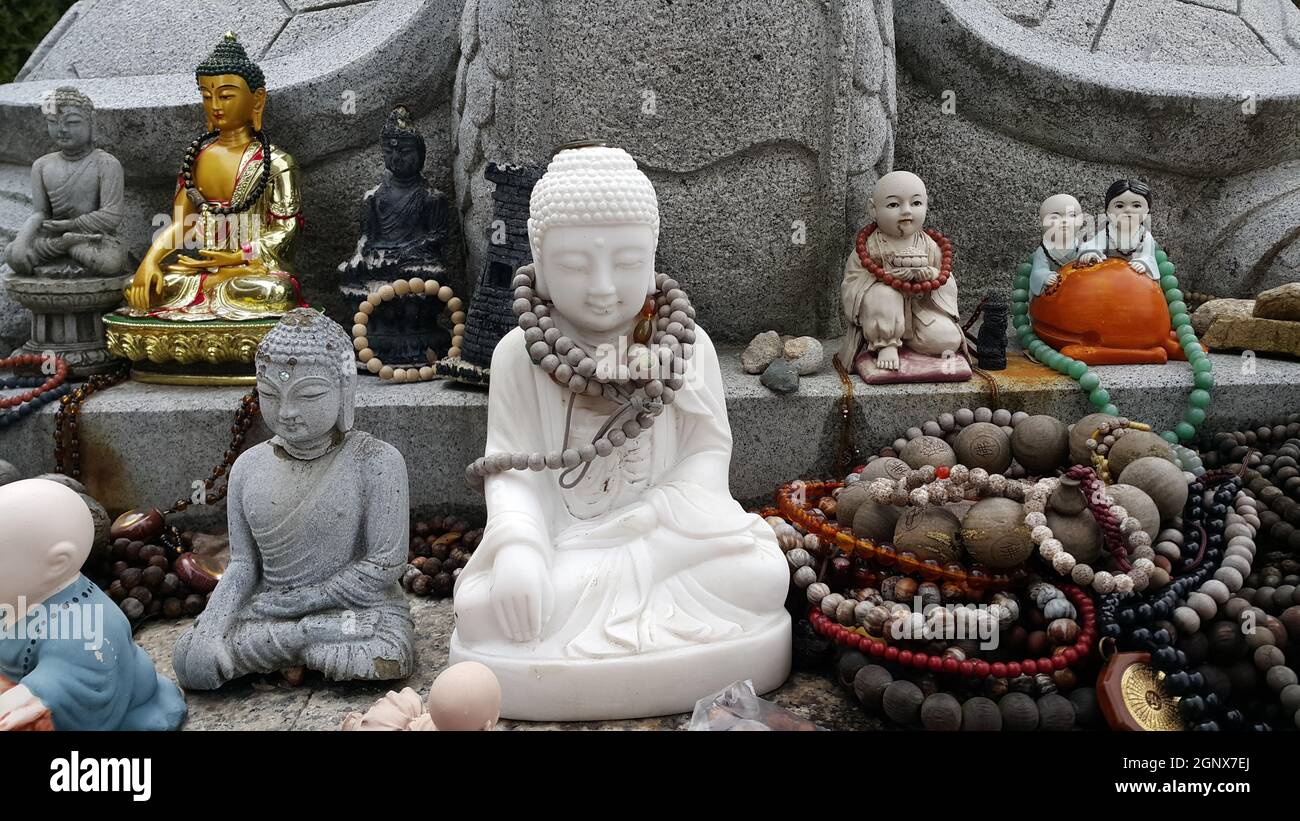 Closeup view of statues of religious monks. Buddha mini statue with ...