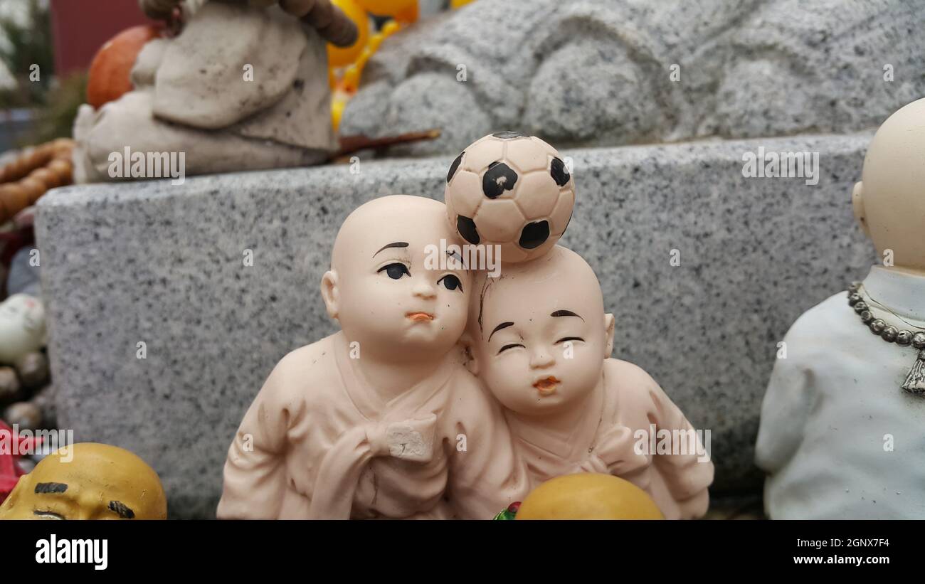 Closeup view of statues of religious monks. Buddha mini statue with ...
