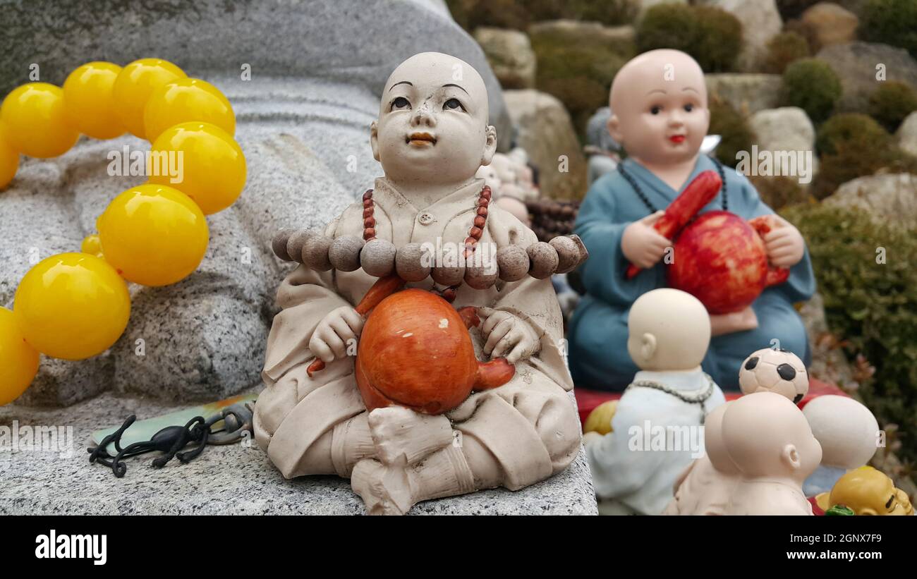 Closeup view of statues of religious monks. Buddha mini statue with ...
