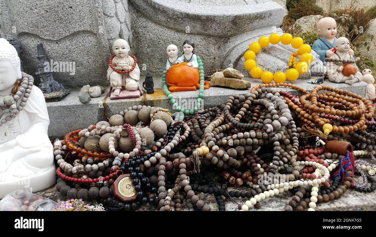 Closeup view of statues of religious monks. Buddha mini statue with ...