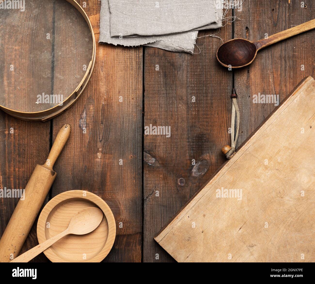 very old wooden kitchen vintage items: sieve, rolling pin, empty spoons ...