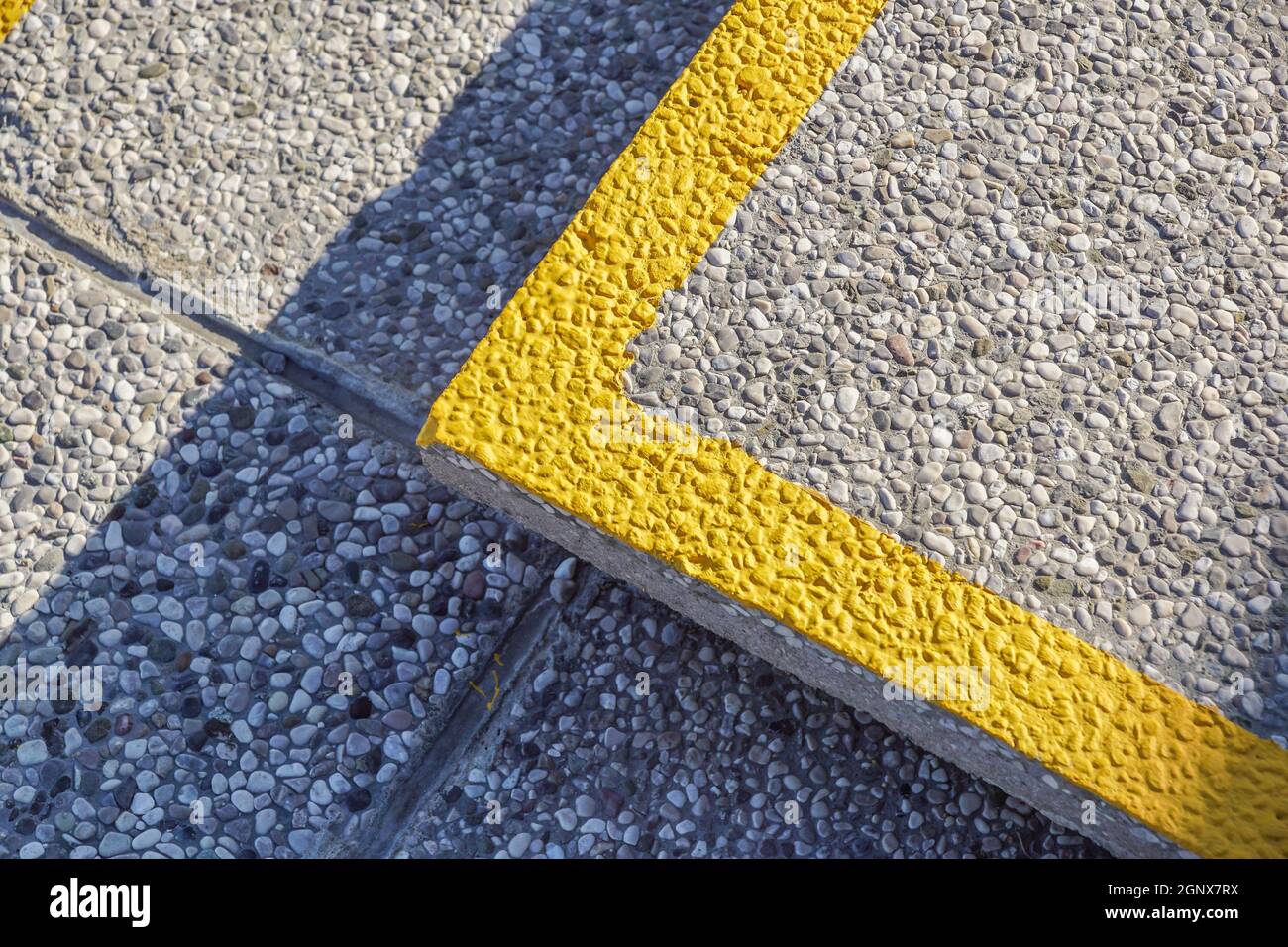 Yellow line at sidewalk with a concrete corner curbstone Stock Photo ...